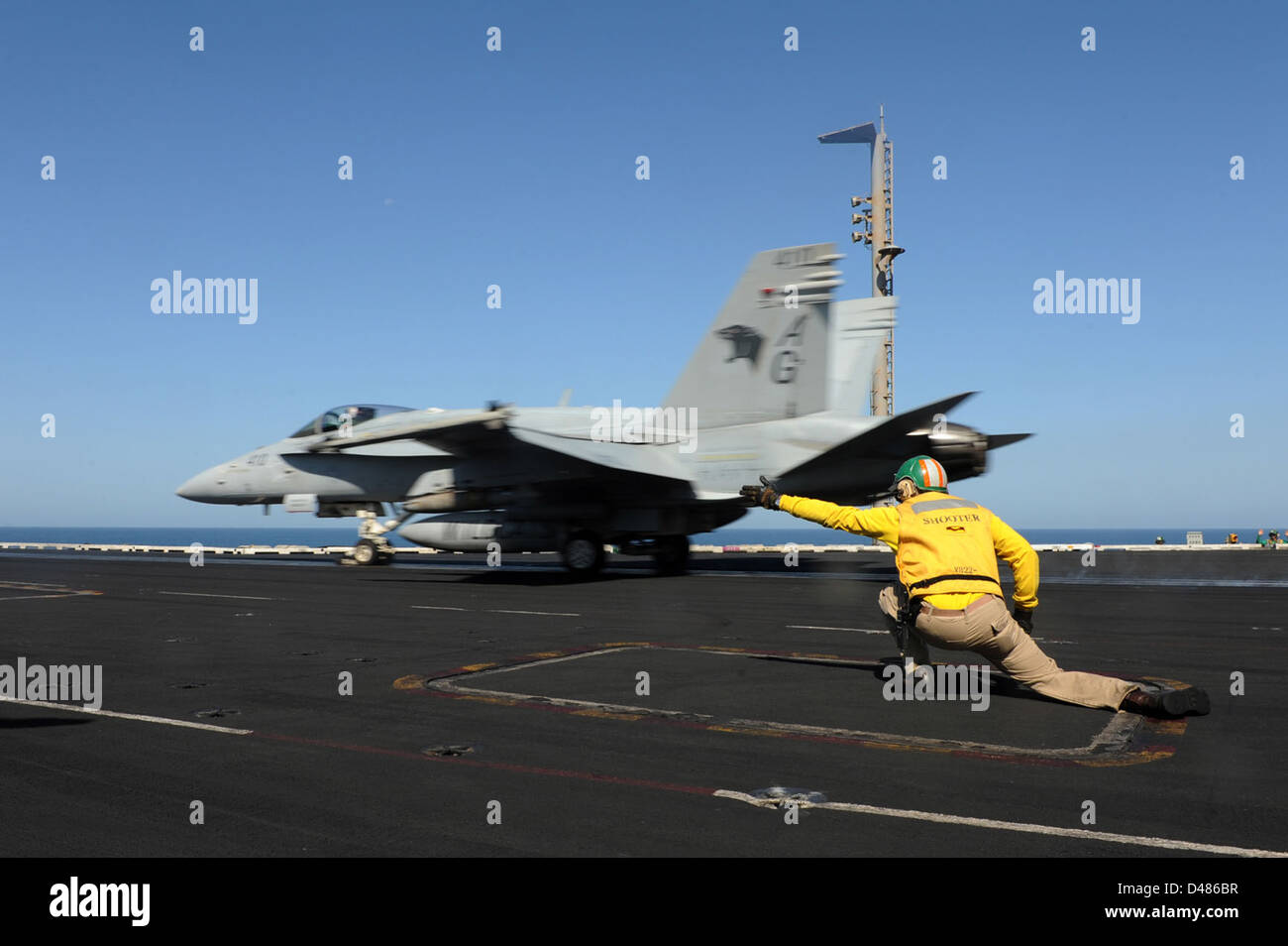 Officer signals launch of an F/A-18C Stock Photo - Alamy
