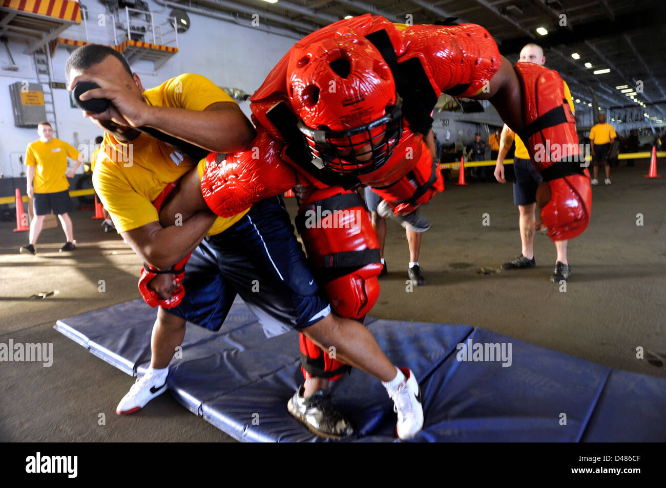 A U.S. Navy Sailor participates in security training, engaging in ...