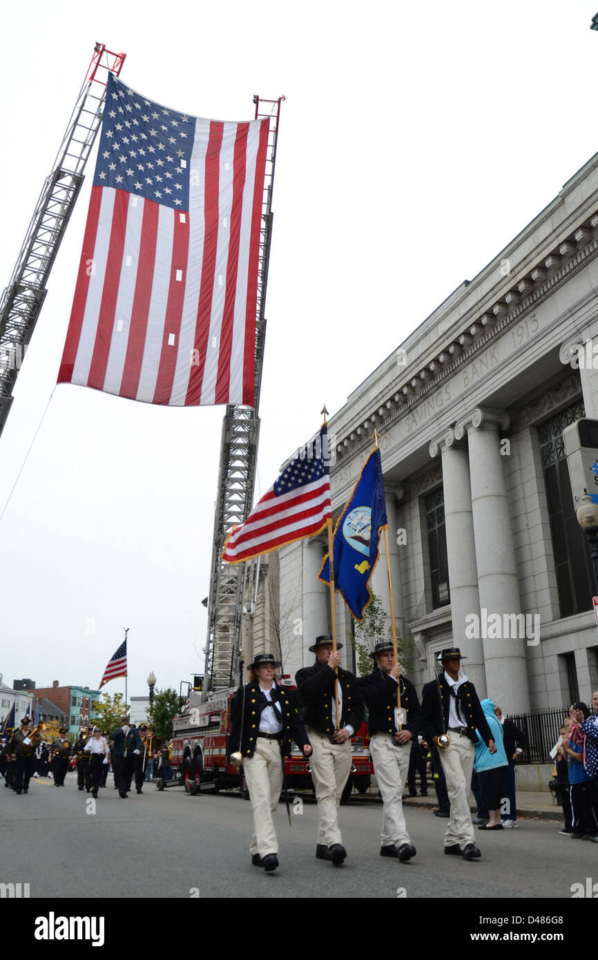 Sailors from the USS Constitution carry the colors in a parade in ...
