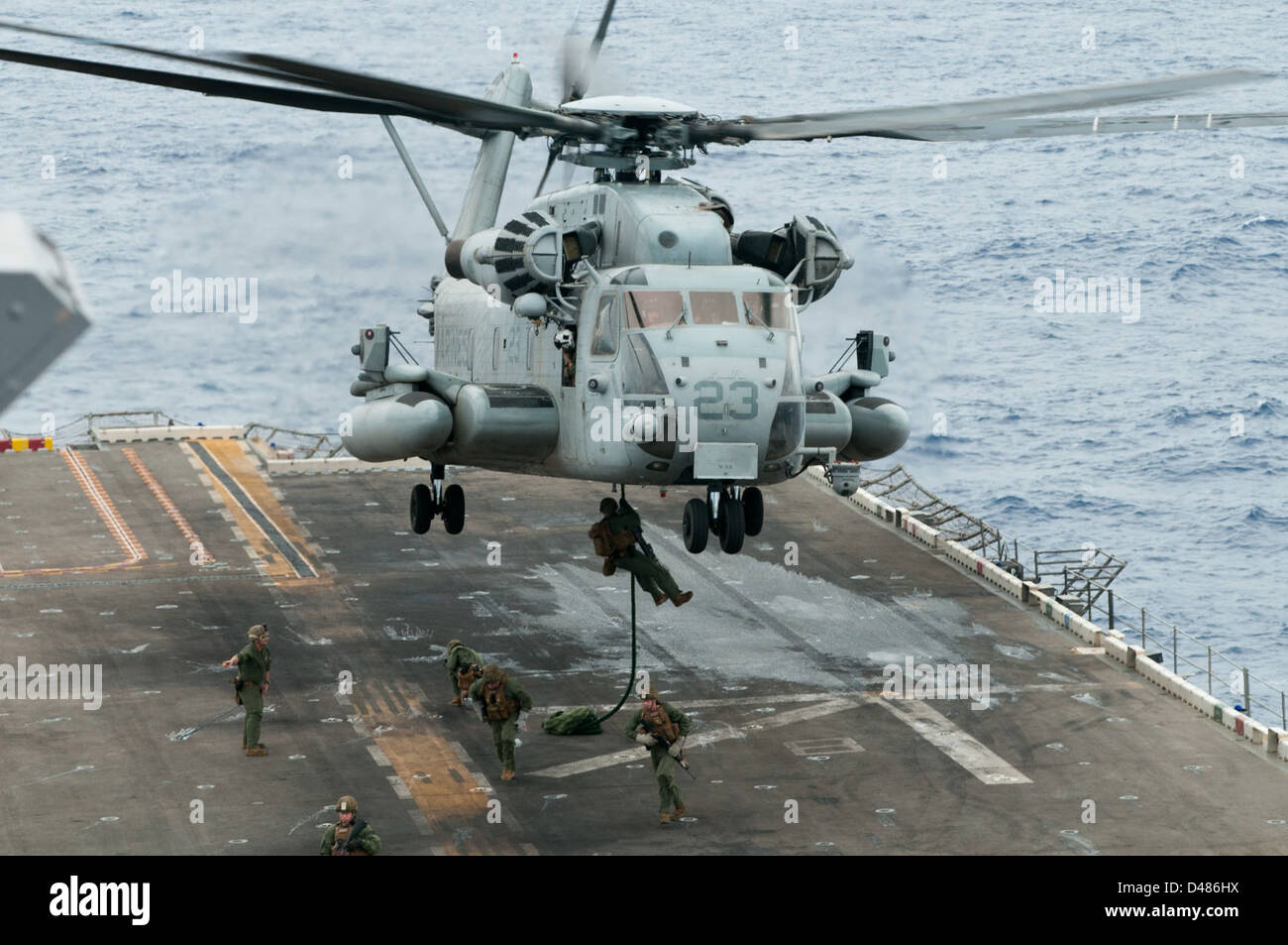 Marines fast-rope from a helicopter Stock Photo - Alamy