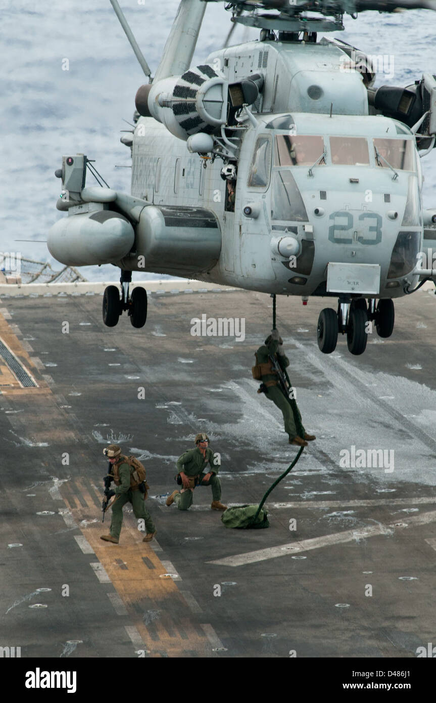 Marines fast-rope from a helicopter Stock Photo - Alamy