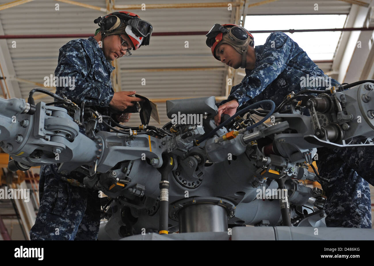 Sailors work on a helicopter Stock Photo - Alamy