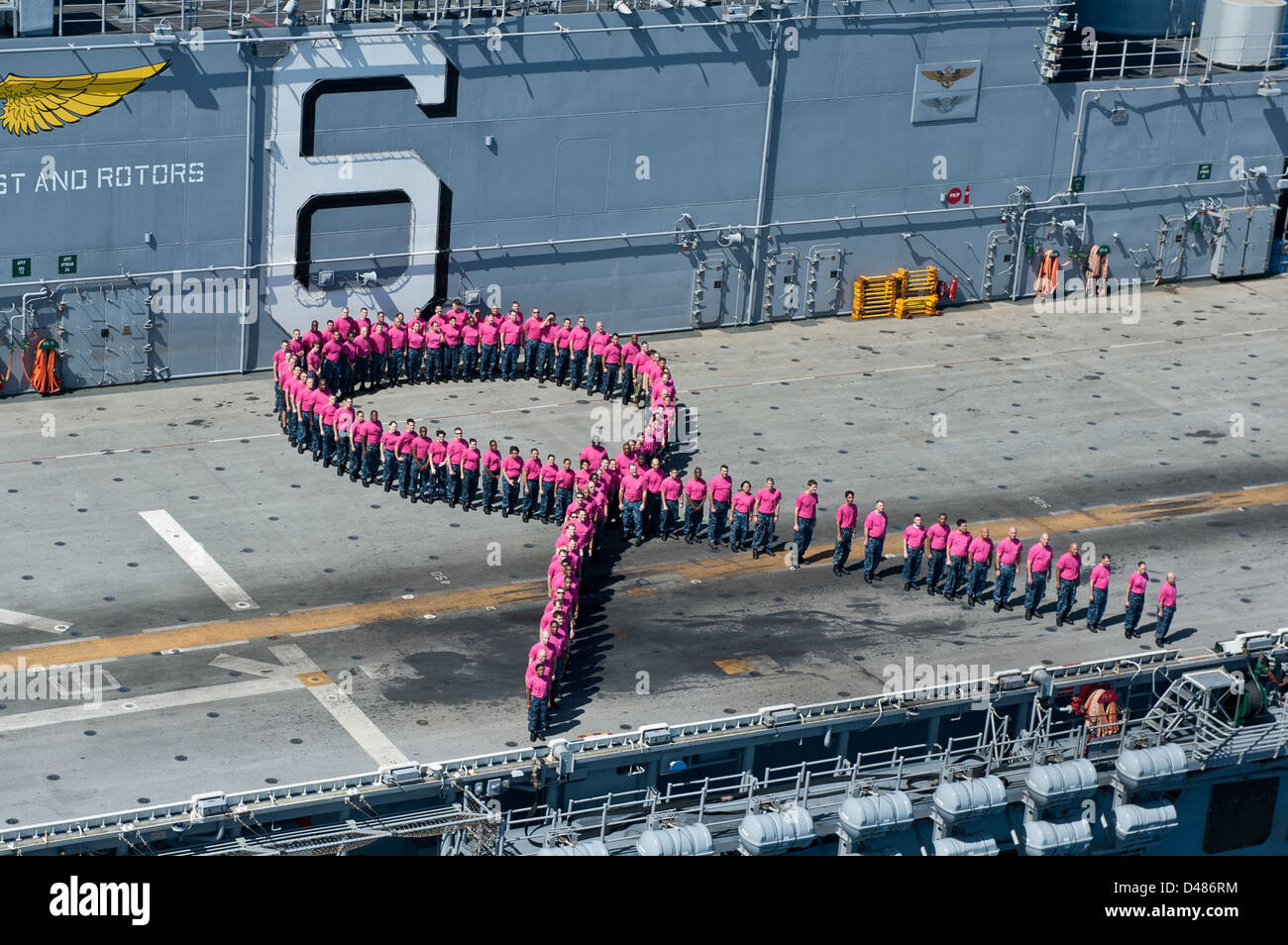 Sailors stand in a pink ribbon formation at sea Stock Photo - Alamy