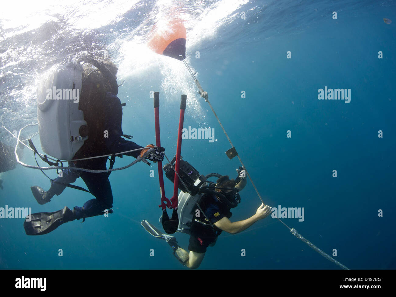 Sailors swim underwater during training exercises as part of their ...