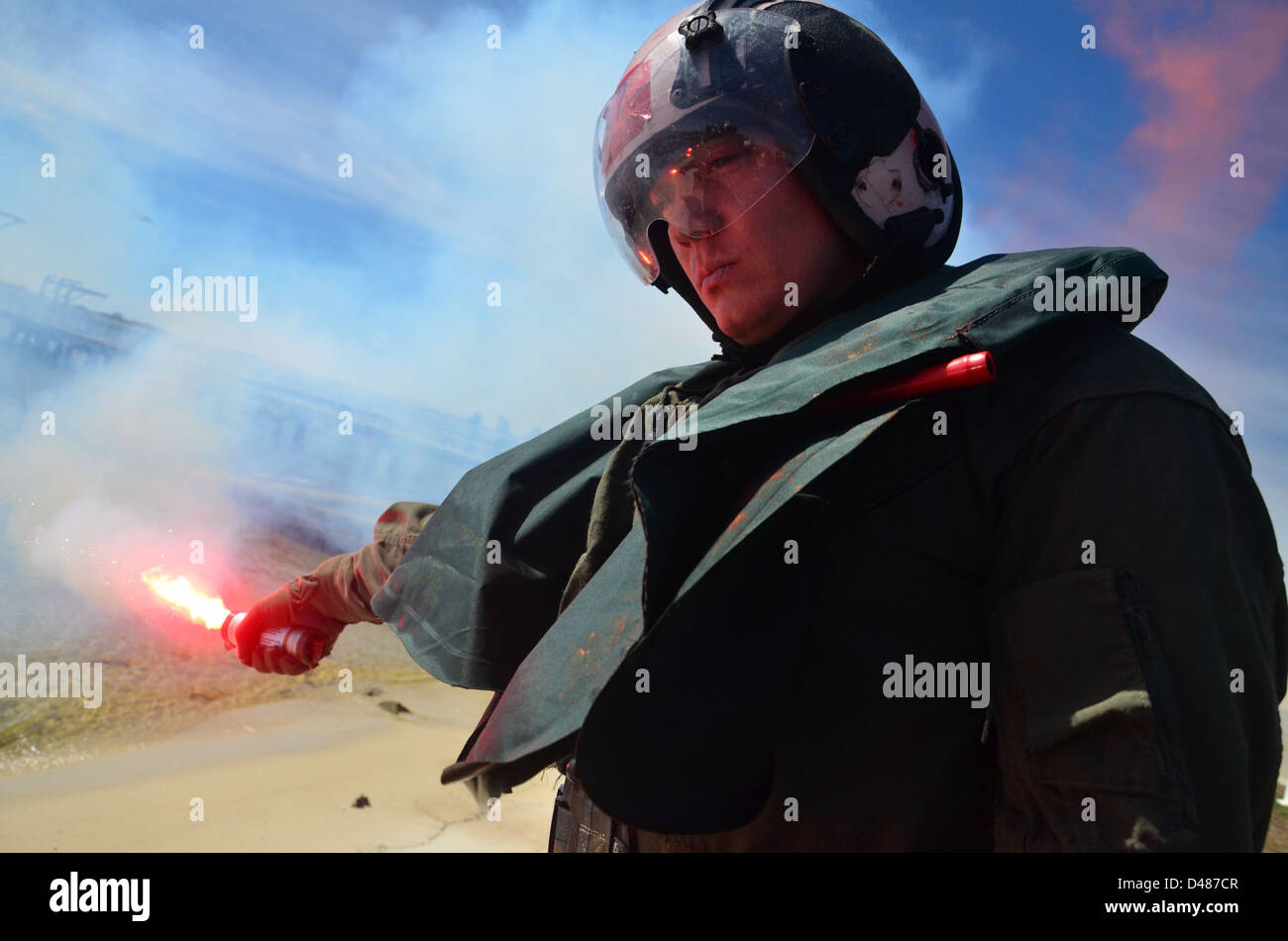 A U.S. Navy officer lights a flare during training at Pensacola ...