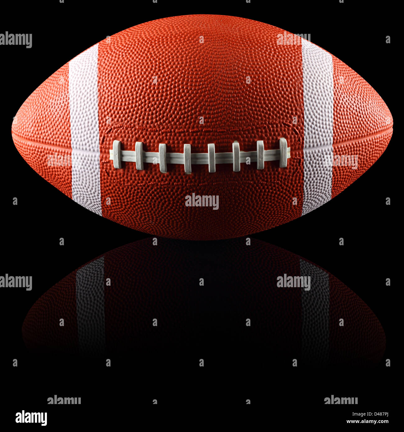 an american football in front of black background Stock Photo - Alamy