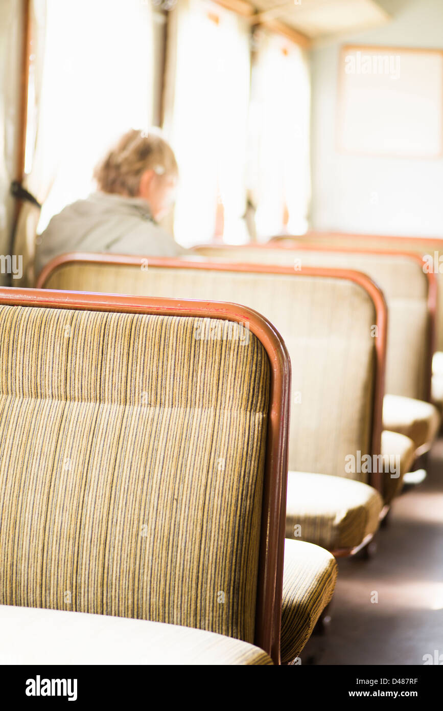 Lonely elderly female sitting alone in a train, out of focus Stock ...