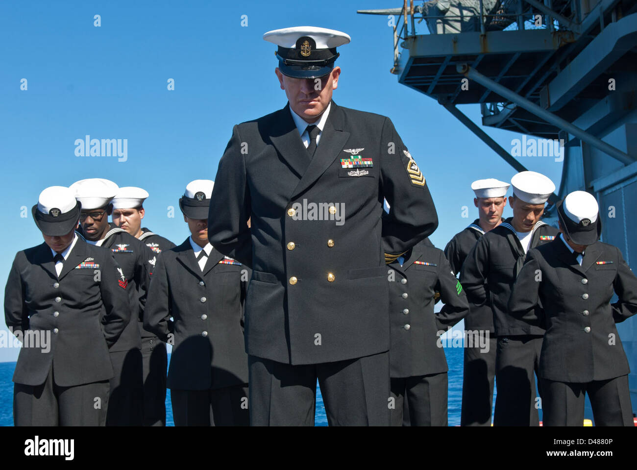 Sailors bow their heads during a burial at sea Stock Photo - Alamy
