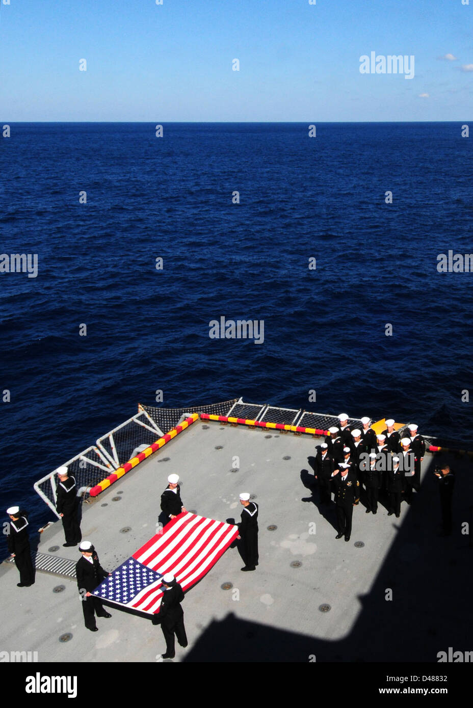 U.S. Navy sailors conduct a burial at sea in the Atlantic Ocean ...
