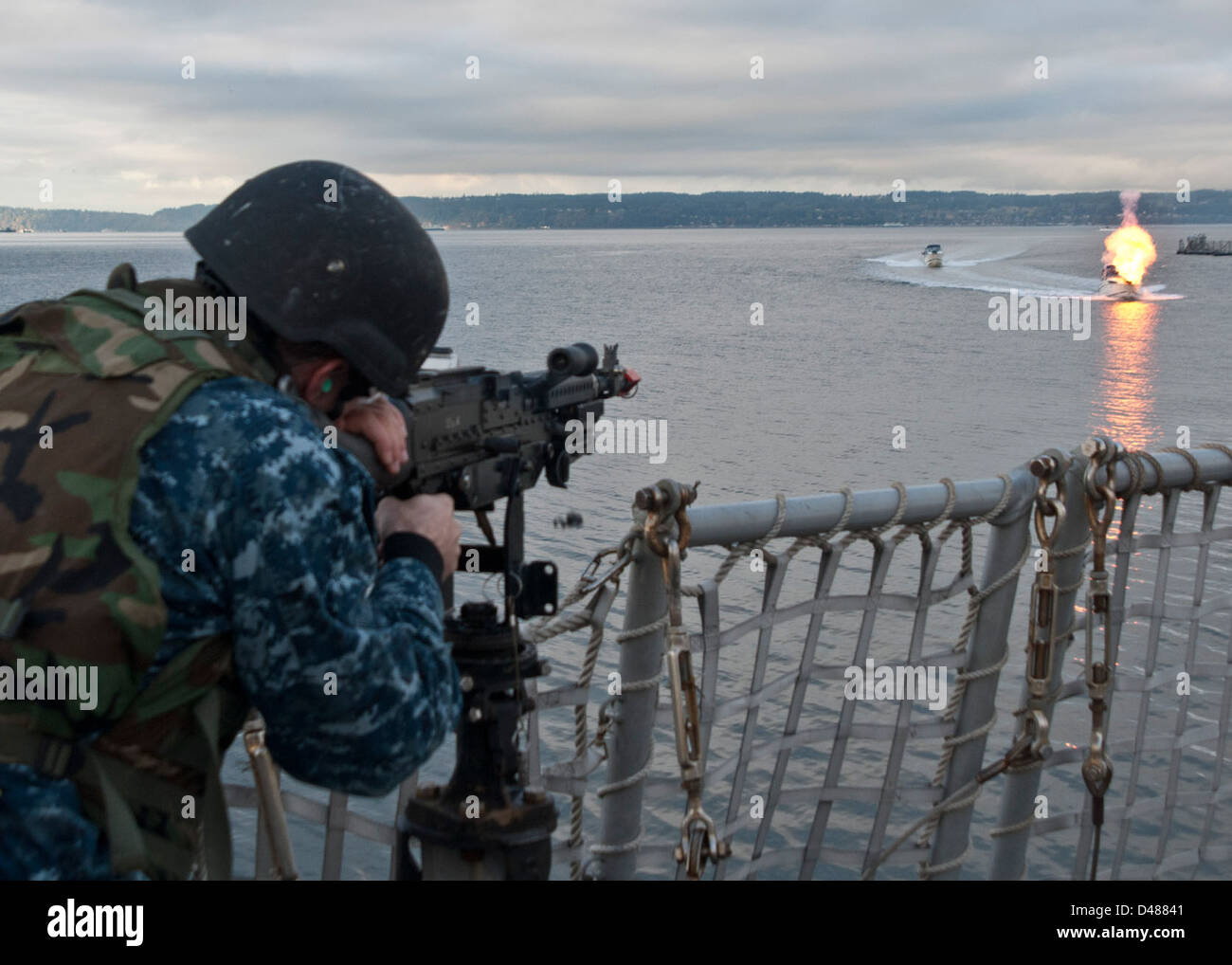 A Sailor fires blanks at a simulated enemy boat Stock Photo - Alamy