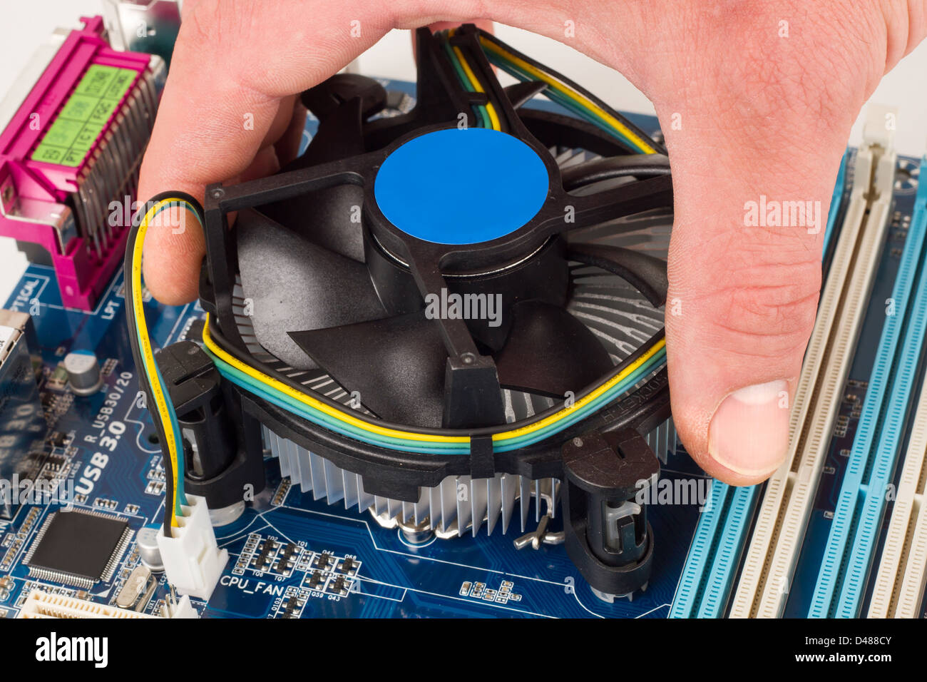 Cpu cooler installation on a mainboard Stock Photo - Alamy