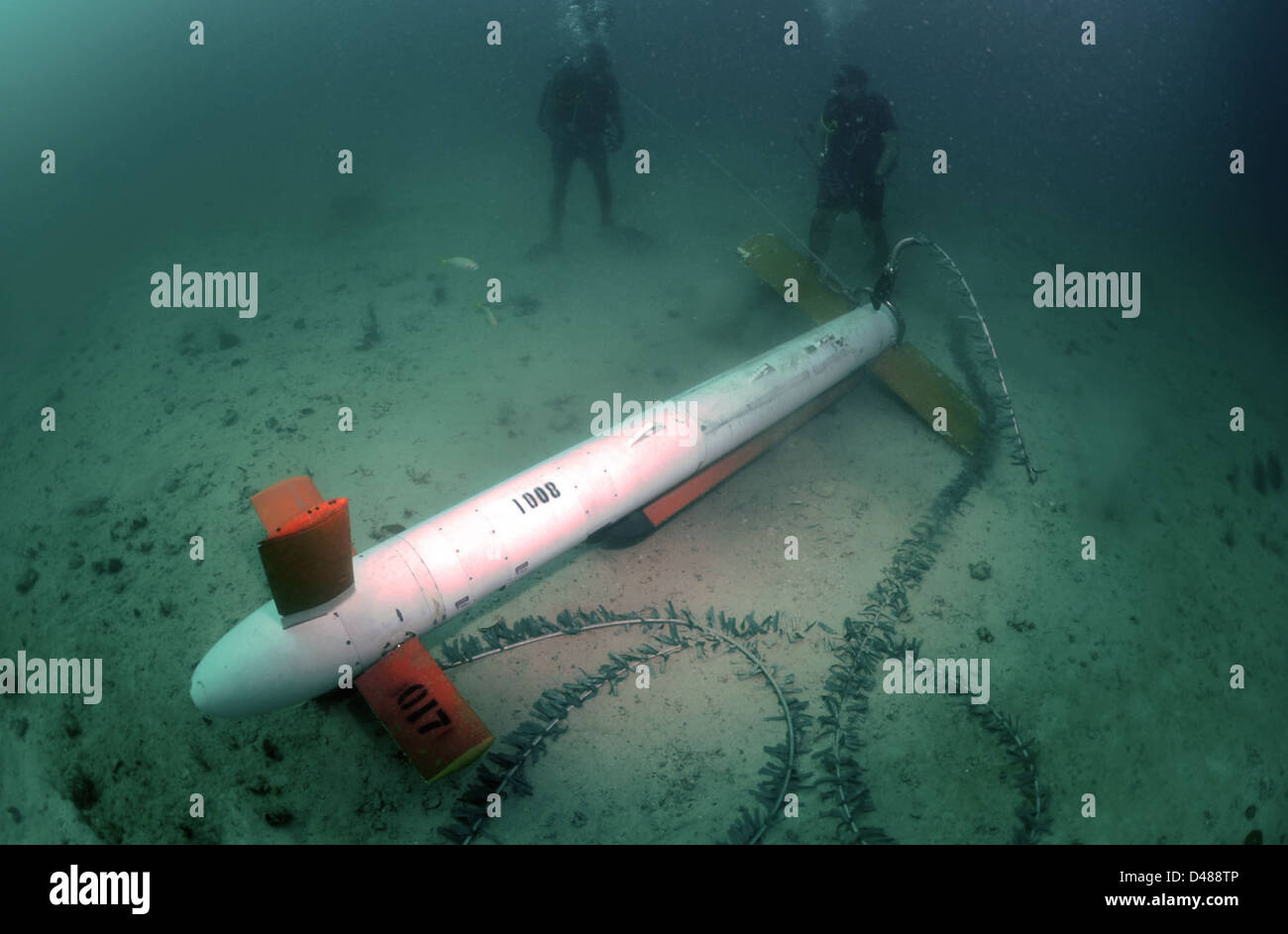 Navy divers recover an airborne mine countermeasure device in the ...