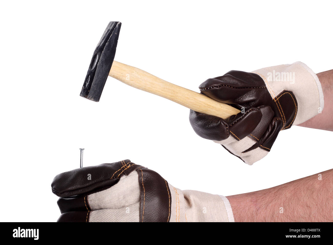 Hammer in working hands with glove hitting a nail Stock Photo - Alamy