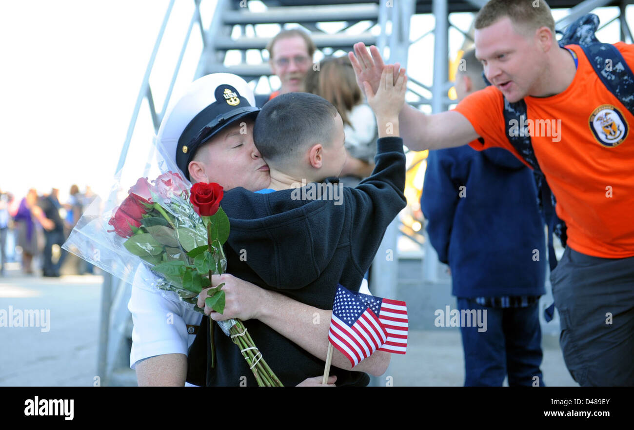 A Sailor kisses his son after returning home to Mayport, Florida ...