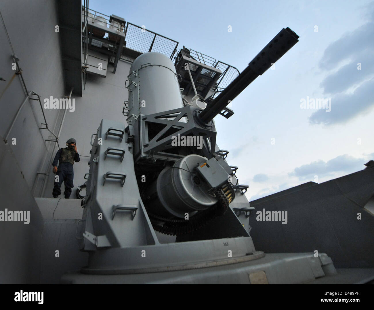A Sailor stands safety watch behind a CIWS Stock Photo - Alamy