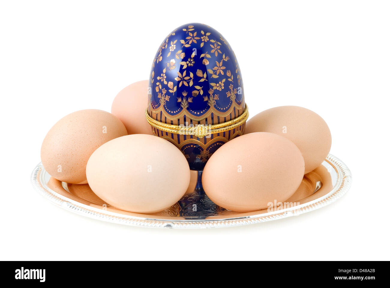 The Easter eggs and casket for jewelry on a silver plate Stock Photo ...