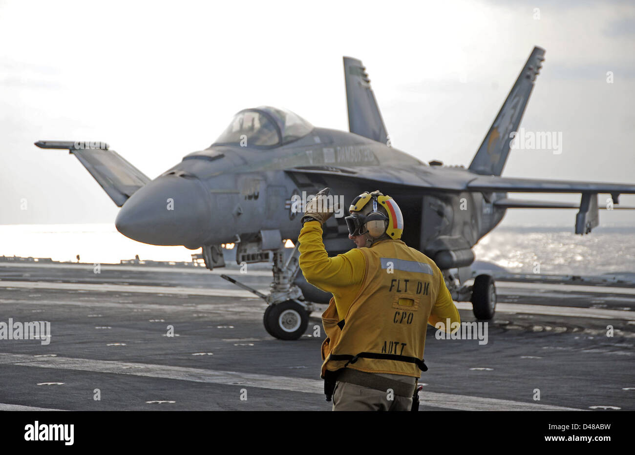 A Sailor directs an F/A-18E Stock Photo - Alamy