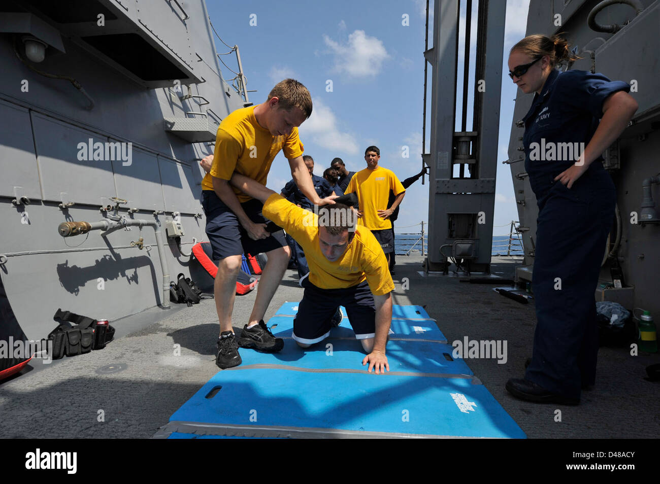A Sailor aboard a U.S. Navy vessel practices takedown techniques ...
