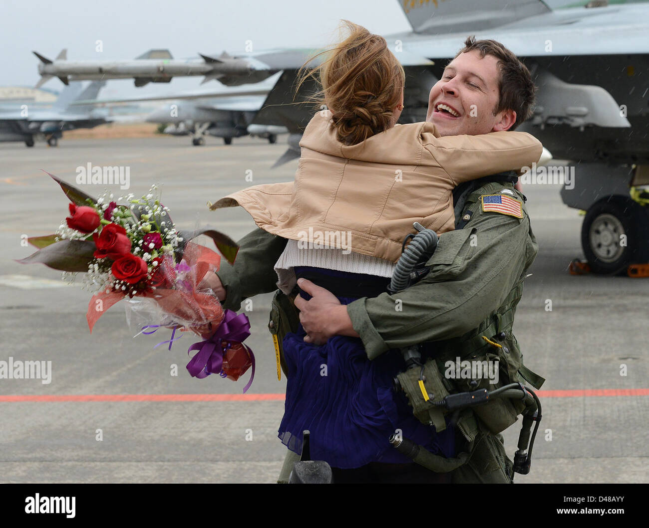 An aviator hugs his girlfriend Stock Photo - Alamy
