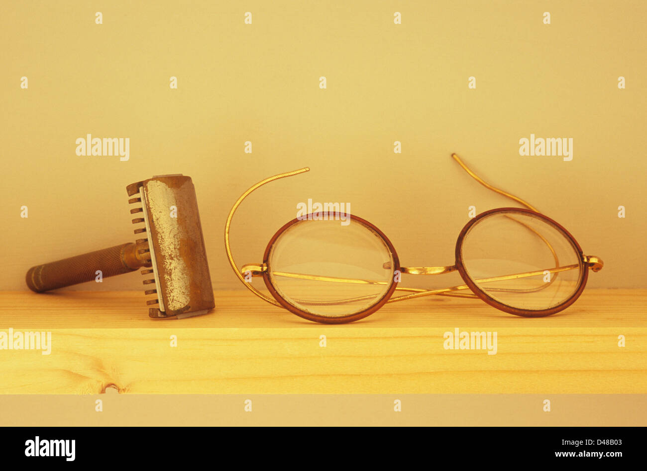 Eye-level view of narrow wooden shelf with tarnished razor and vintage ...