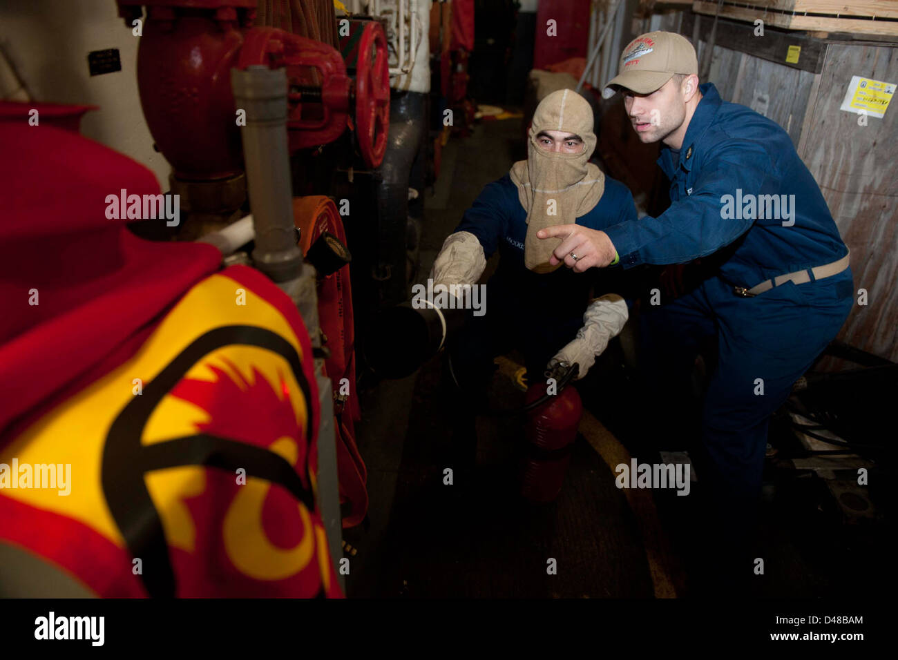 Sailors practice fire fighting at sea Stock Photo - Alamy