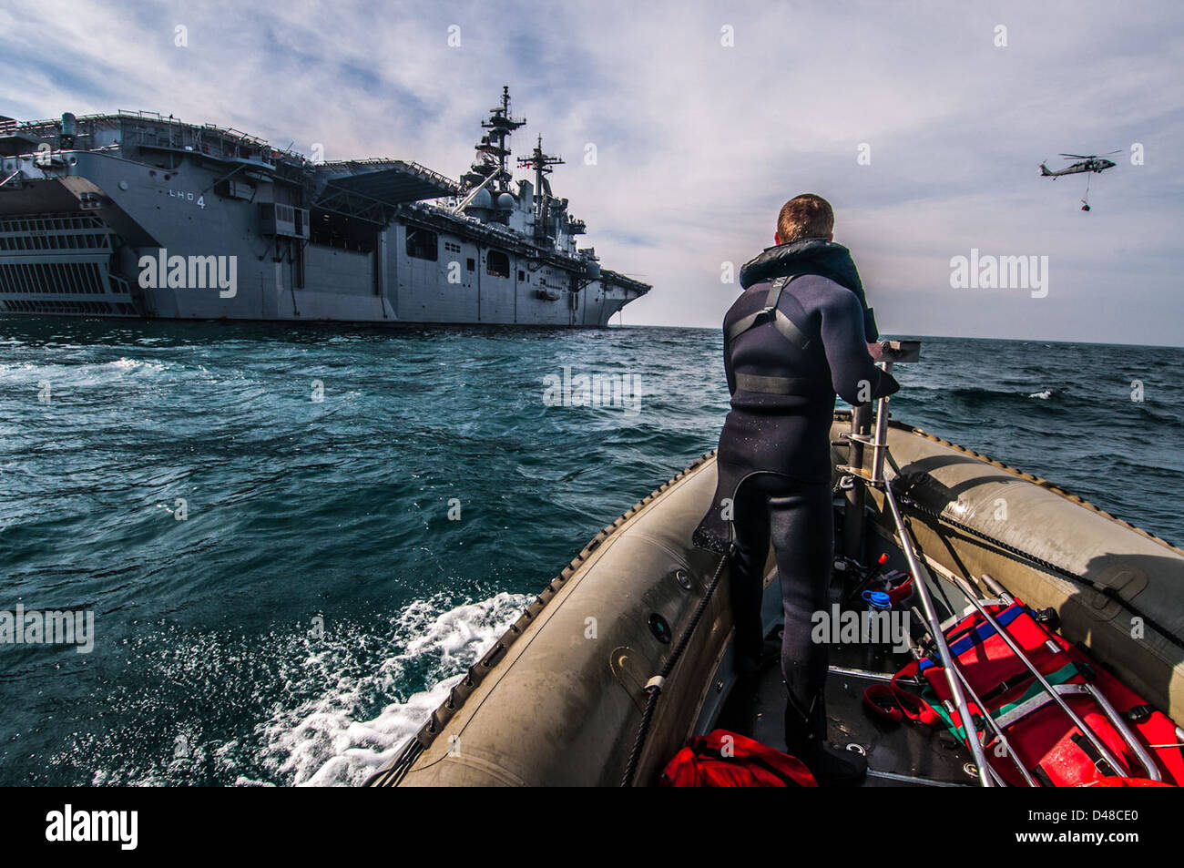 A Sailor stands watch near USS Boxer Stock Photo - Alamy