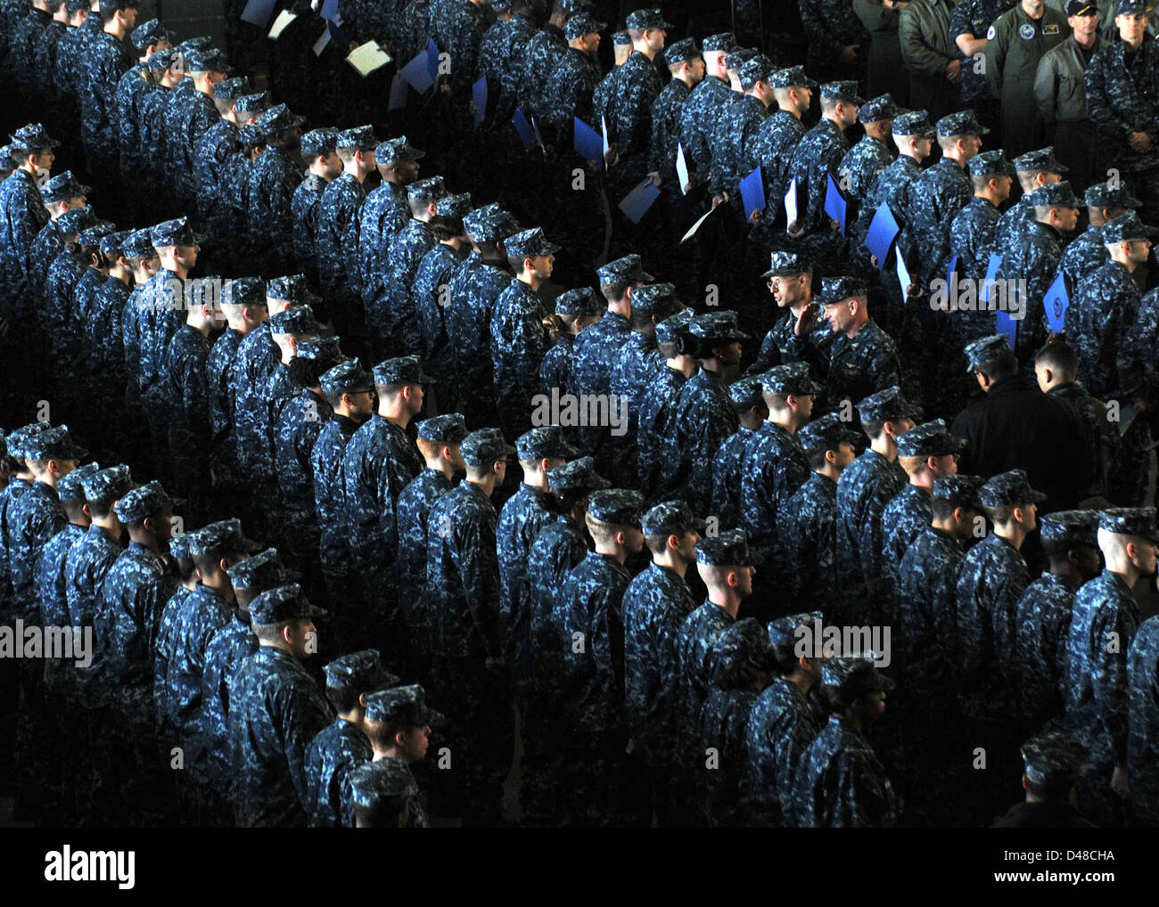 New petty officers of the U.S. Navy stand in formation during a ...