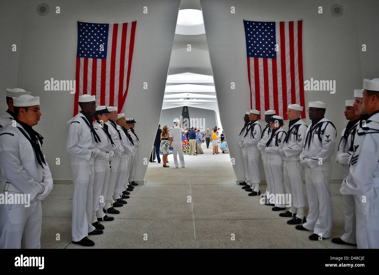 Sailors stand in formation at the USS Arizona Memorial during a ...