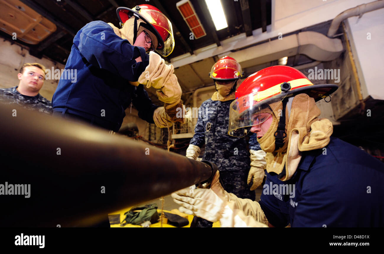 Sailors in Newport News, Virginia, practice pipe patching techniques as ...