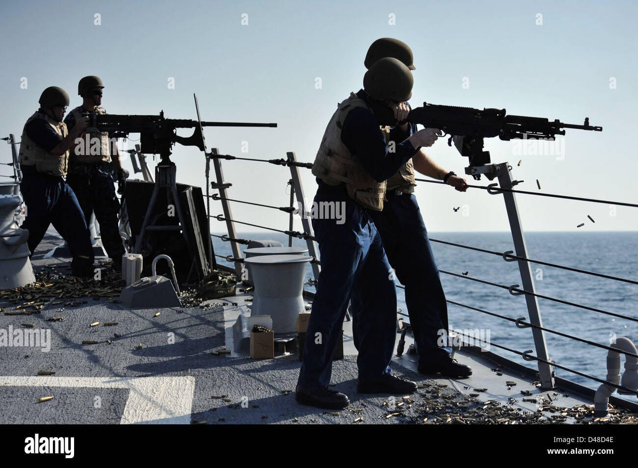 Sailors conduct a live fire exercise in the Arabian Sea as part of ...