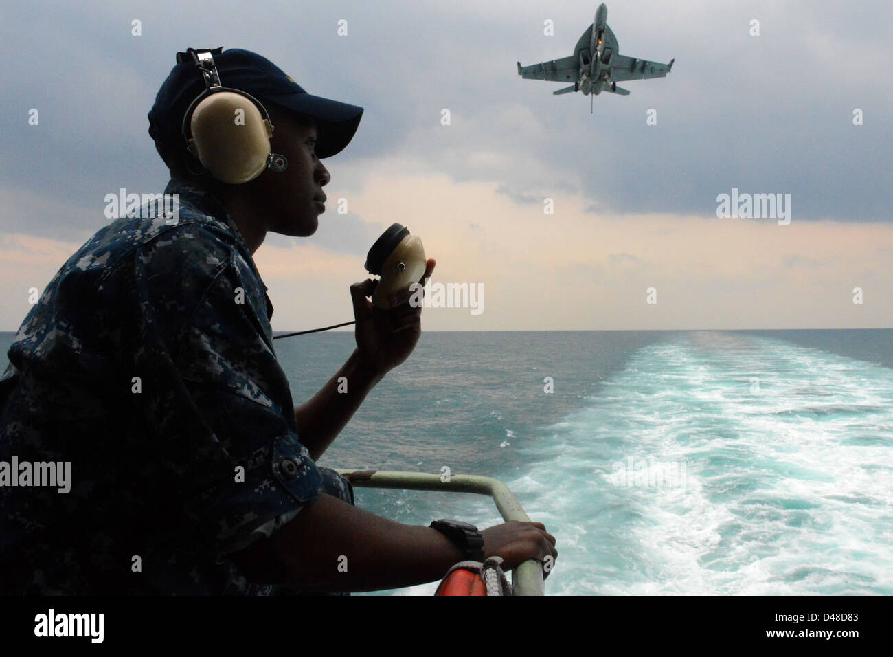 A U S Navy Sailor Stands Watch In The Arabian Sea Ensuring Security
