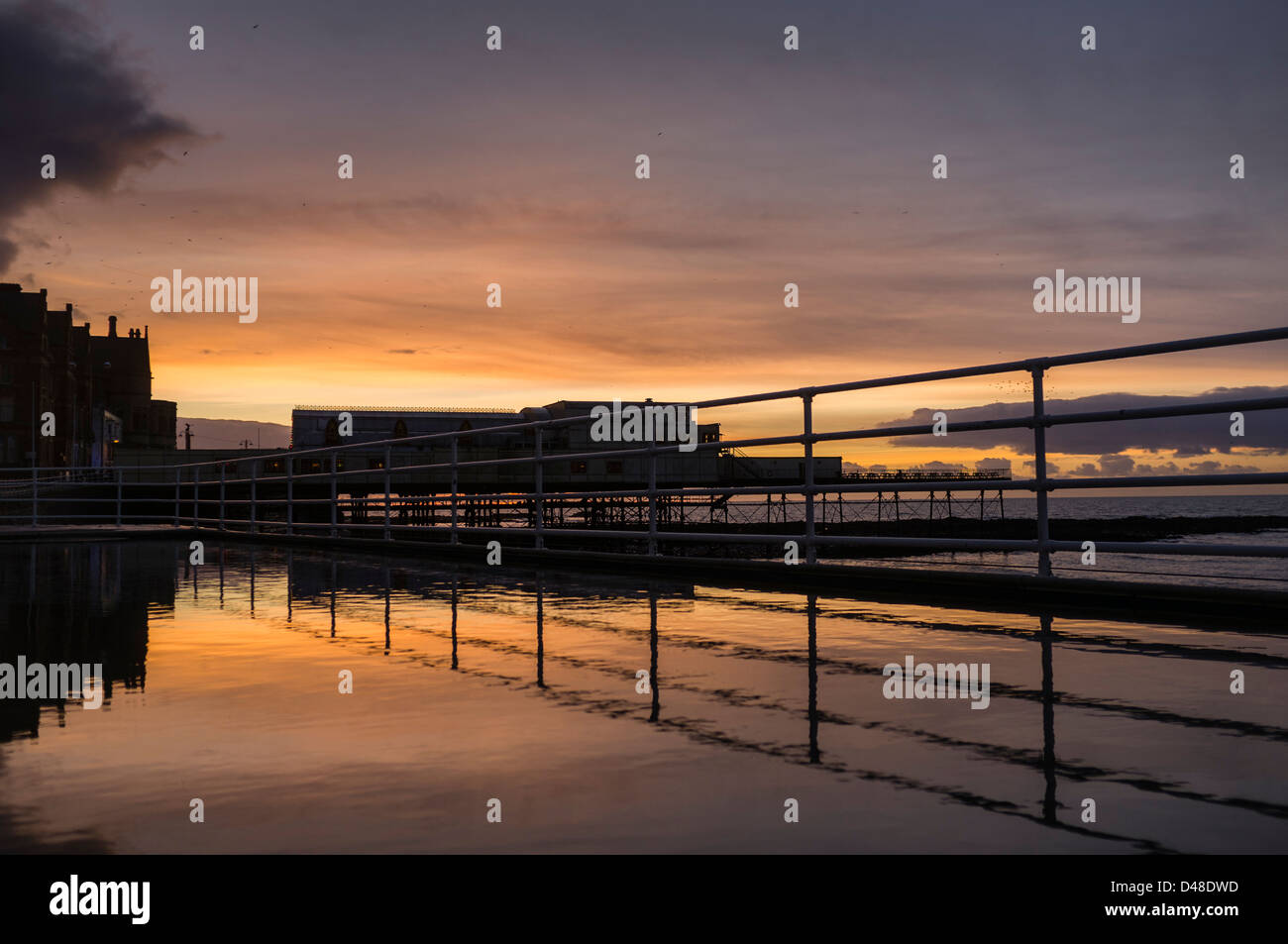 Aberystwyth pier, reflected in a pool of water, dusk, february evening ...