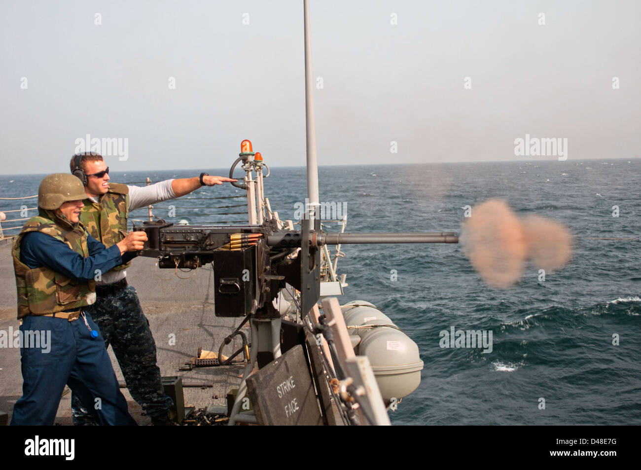 A Sailor fires a .50-caliber machine gun at sea Stock Photo - Alamy