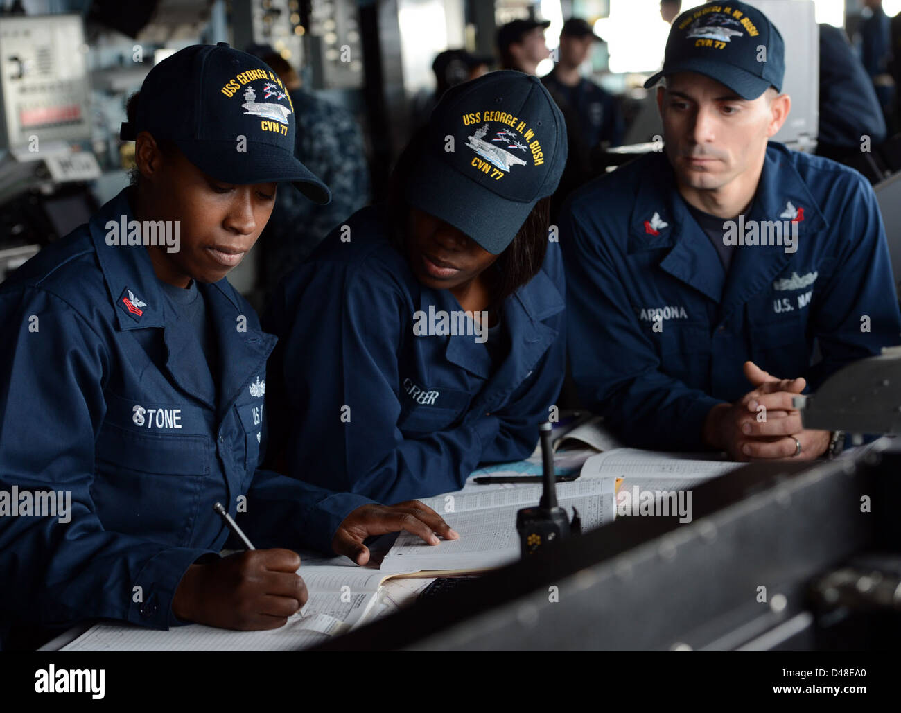 Sailors aboard a naval vessel calculate the sunrise at sea in the ...
