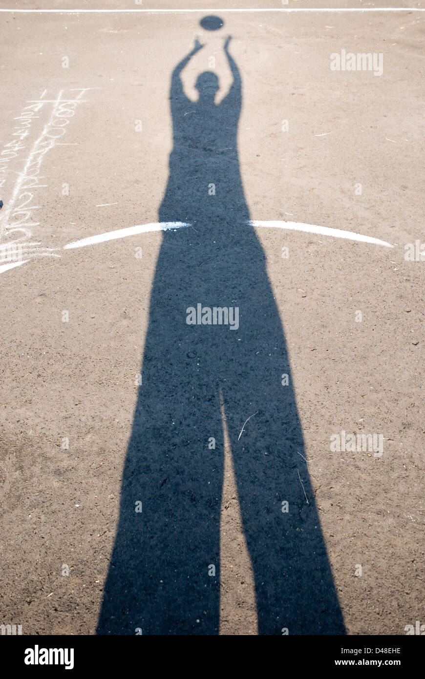 Shadow of basketball player on court Stock Photo - Alamy