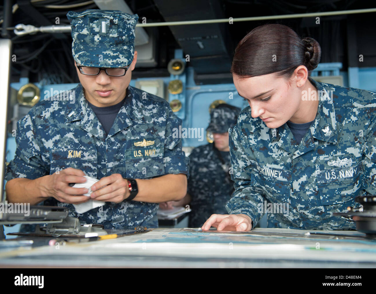 Sailors aboard a U.S. Navy ship plot the ship's course in the Okinawa ...