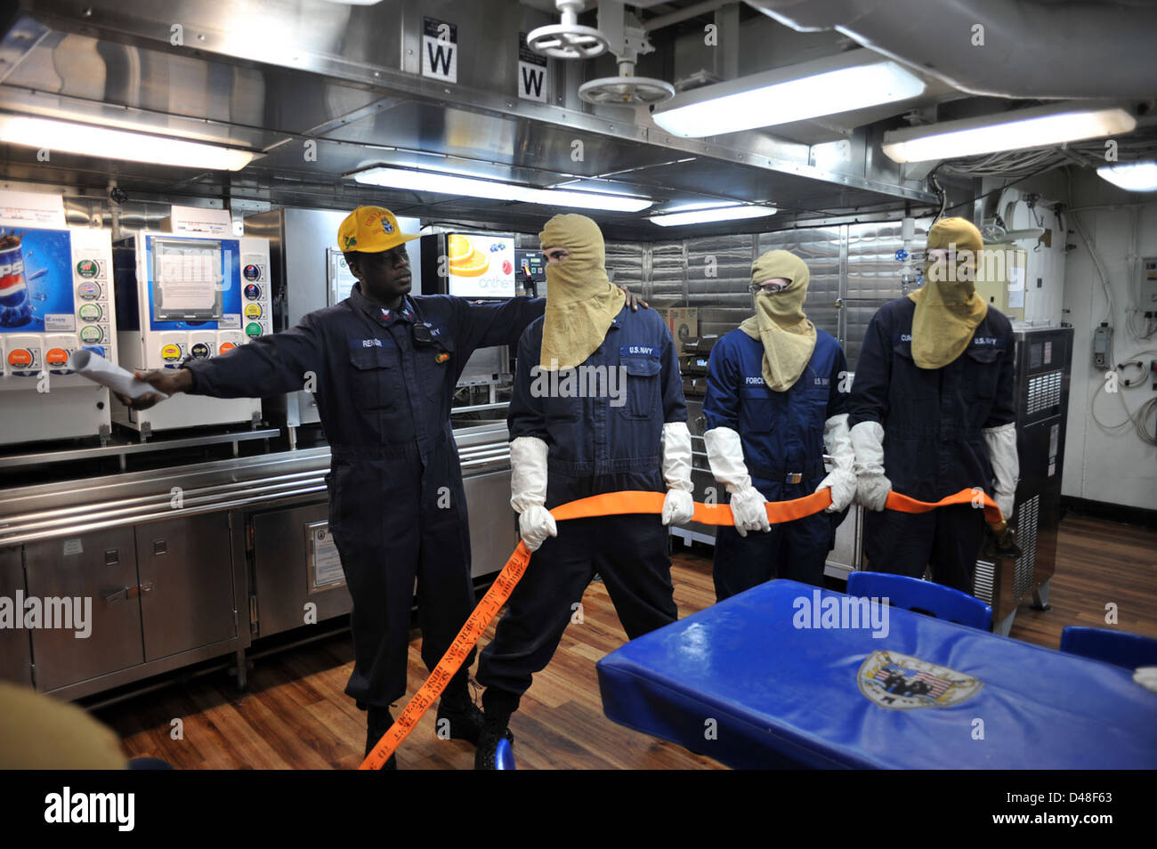 Sailors lean fire fighting procedures at sea Stock Photo - Alamy