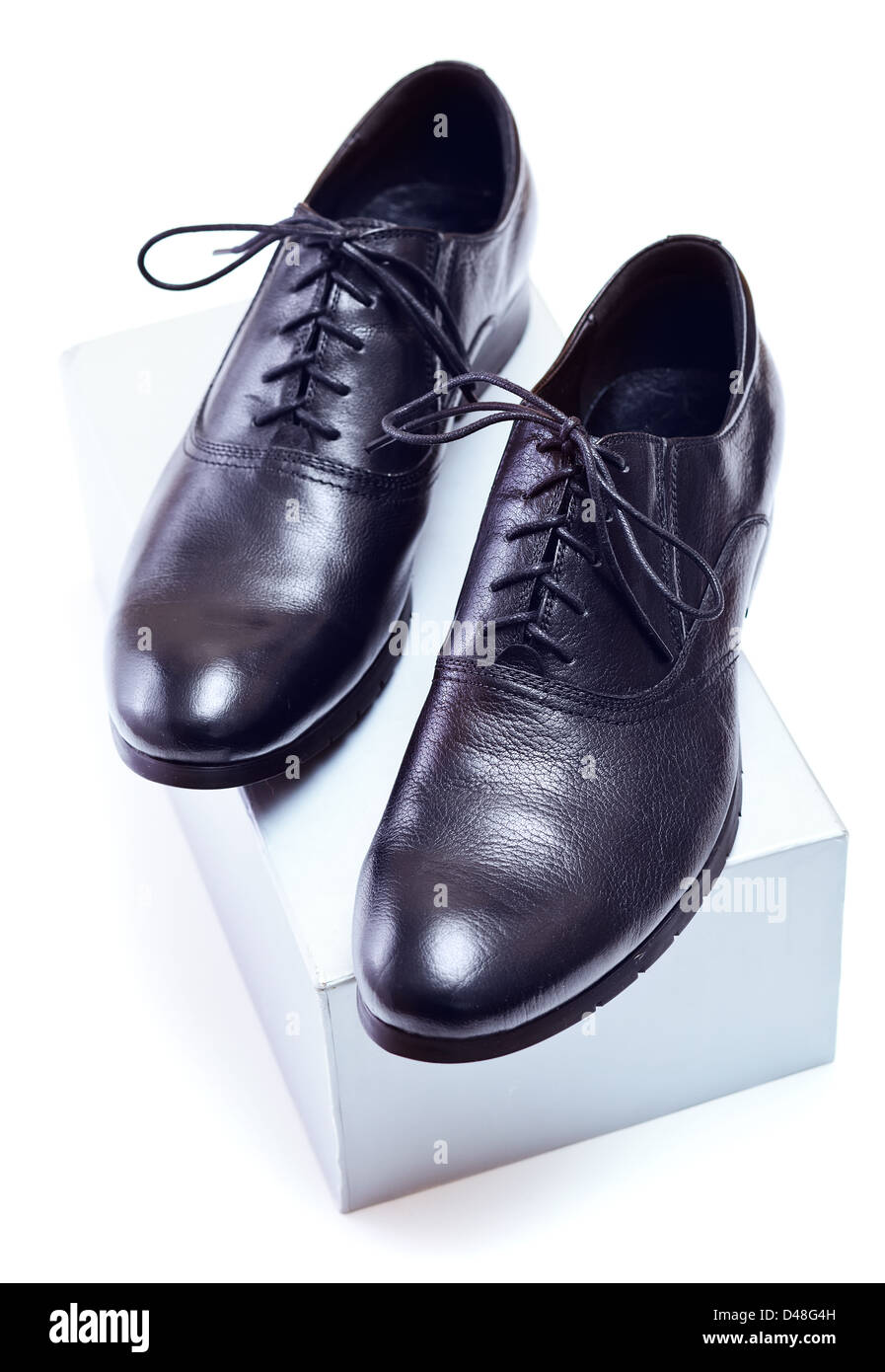 New black shoes with laces and grey box on a white background Stock ...