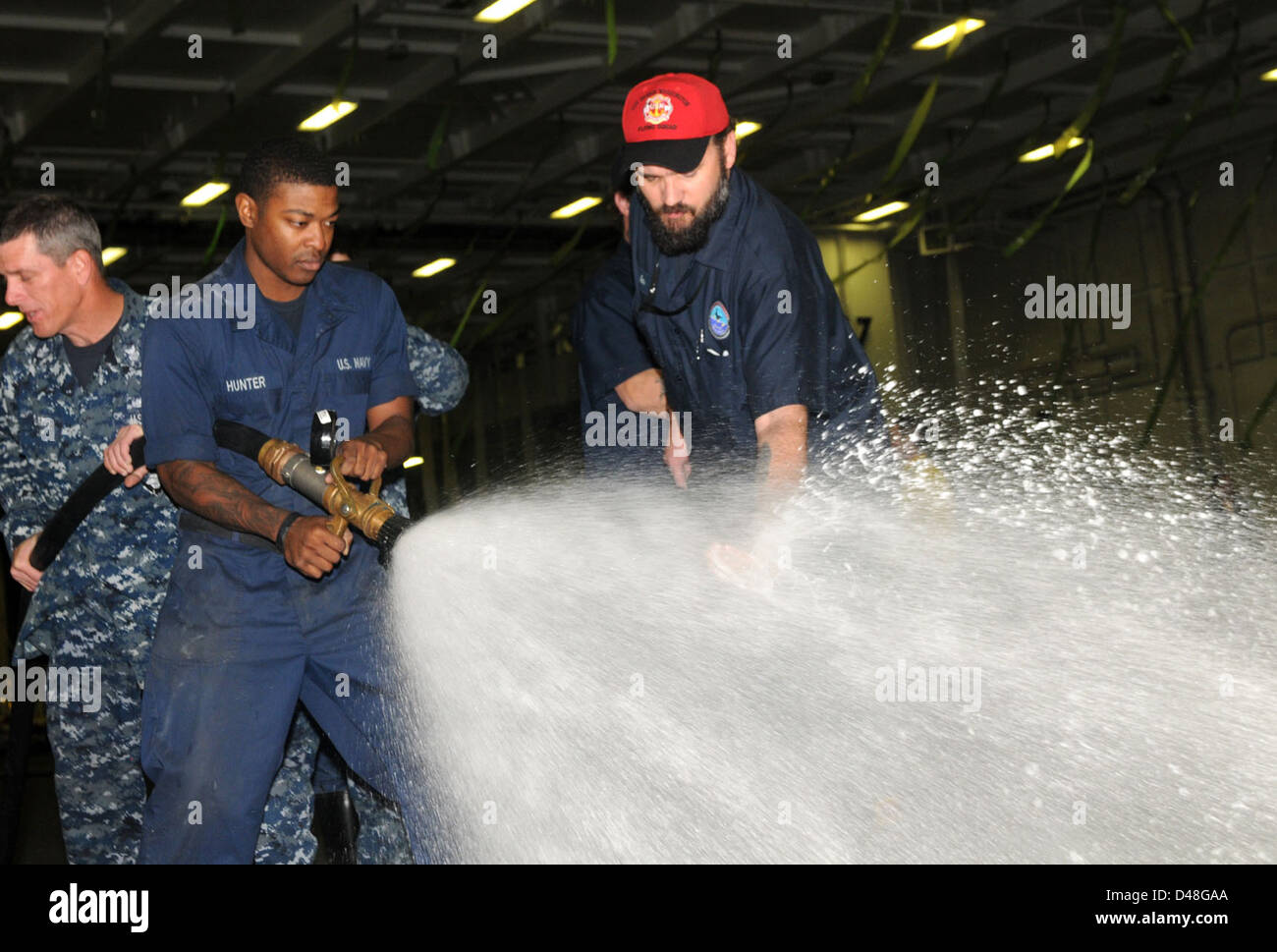 Sailors aboard a U.S. Navy ship test the Aircraft Fire Fighting (AFF ...
