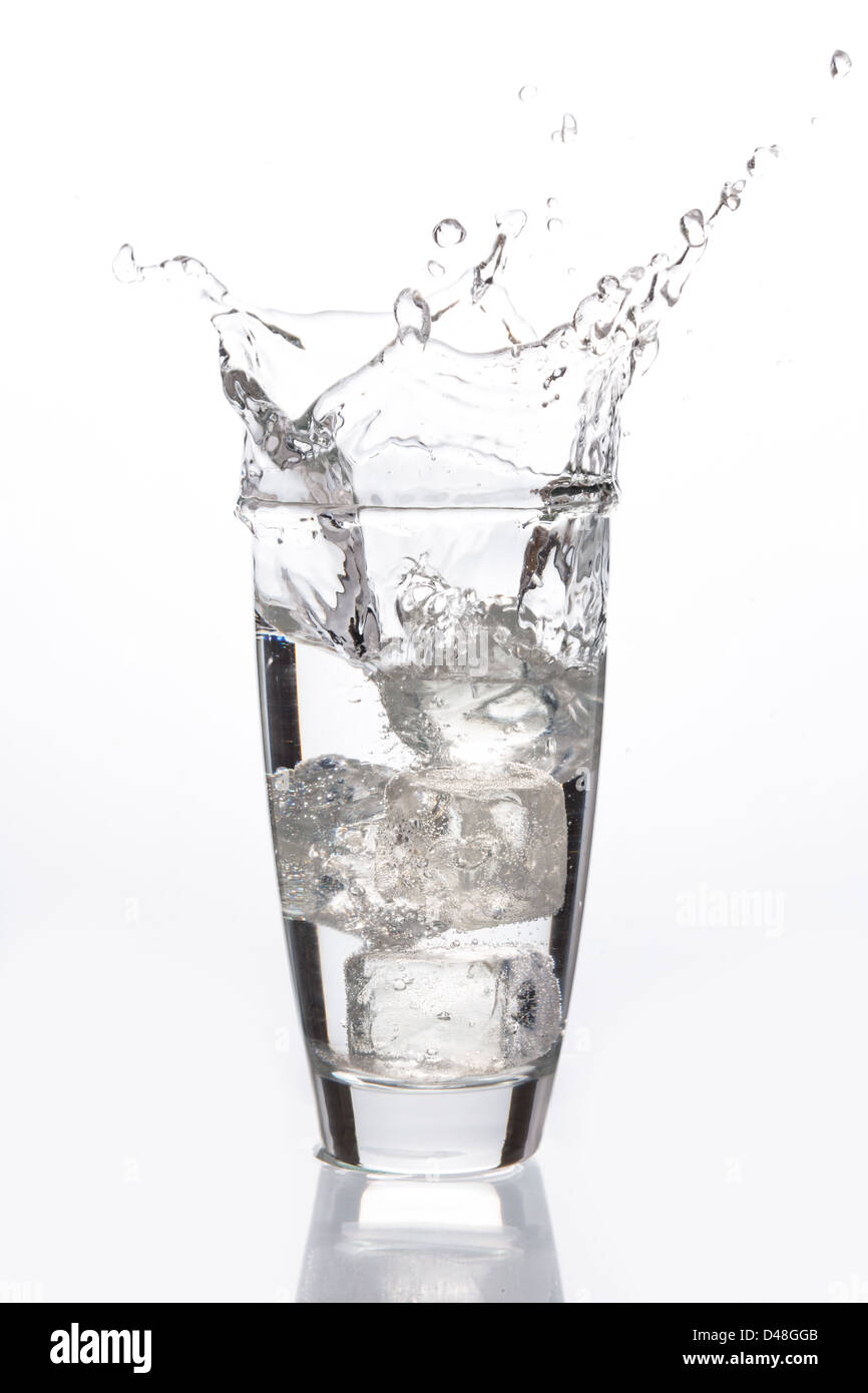 Ice cube falling into glass Stock Photo - Alamy