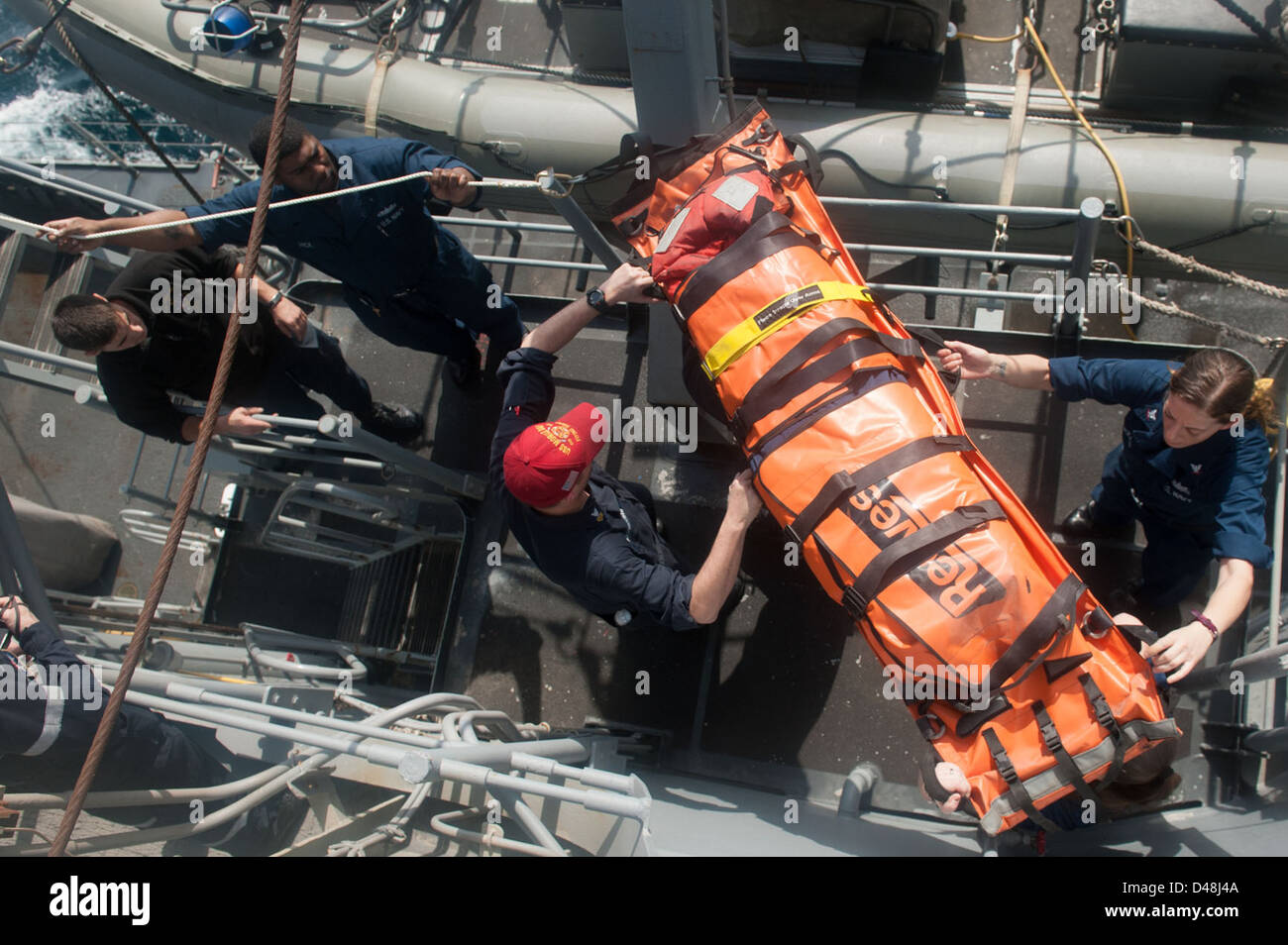 U.S. Navy sailors move a simulated casualty during a medical evacuation ...