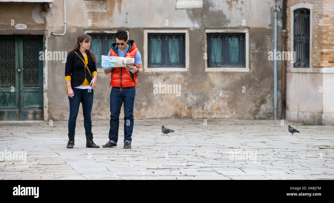 Tourists poring over a map Stock Photo - Alamy