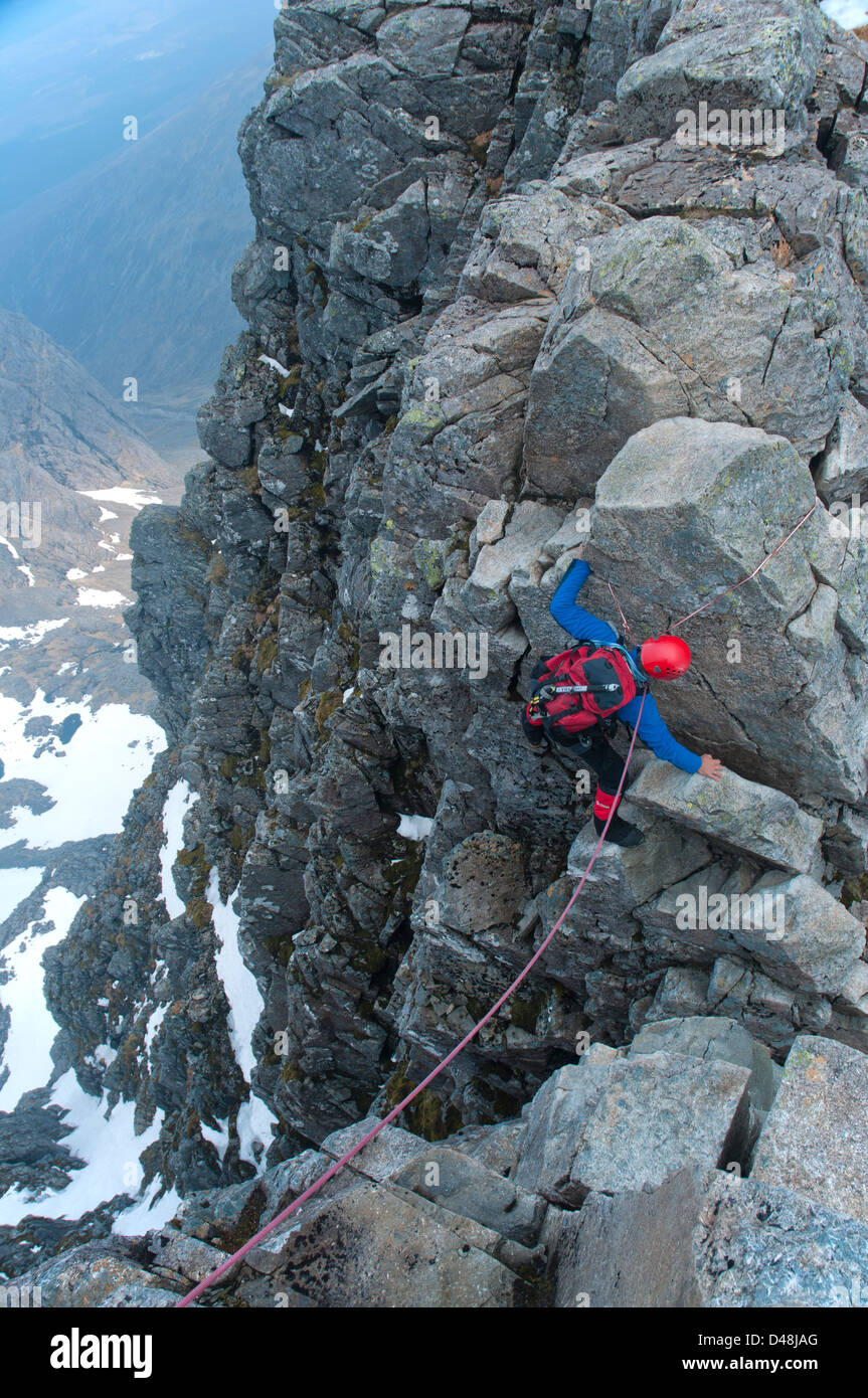 Climber descends into a gap on a classic Ben Nevis route Tower Ridge ...