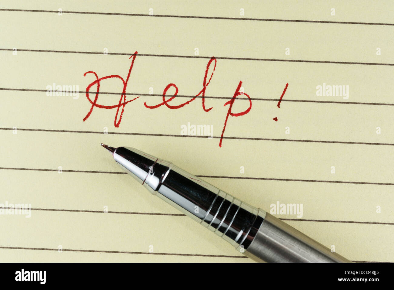 Help word written on lined paper with a pen on it Stock Photo - Alamy