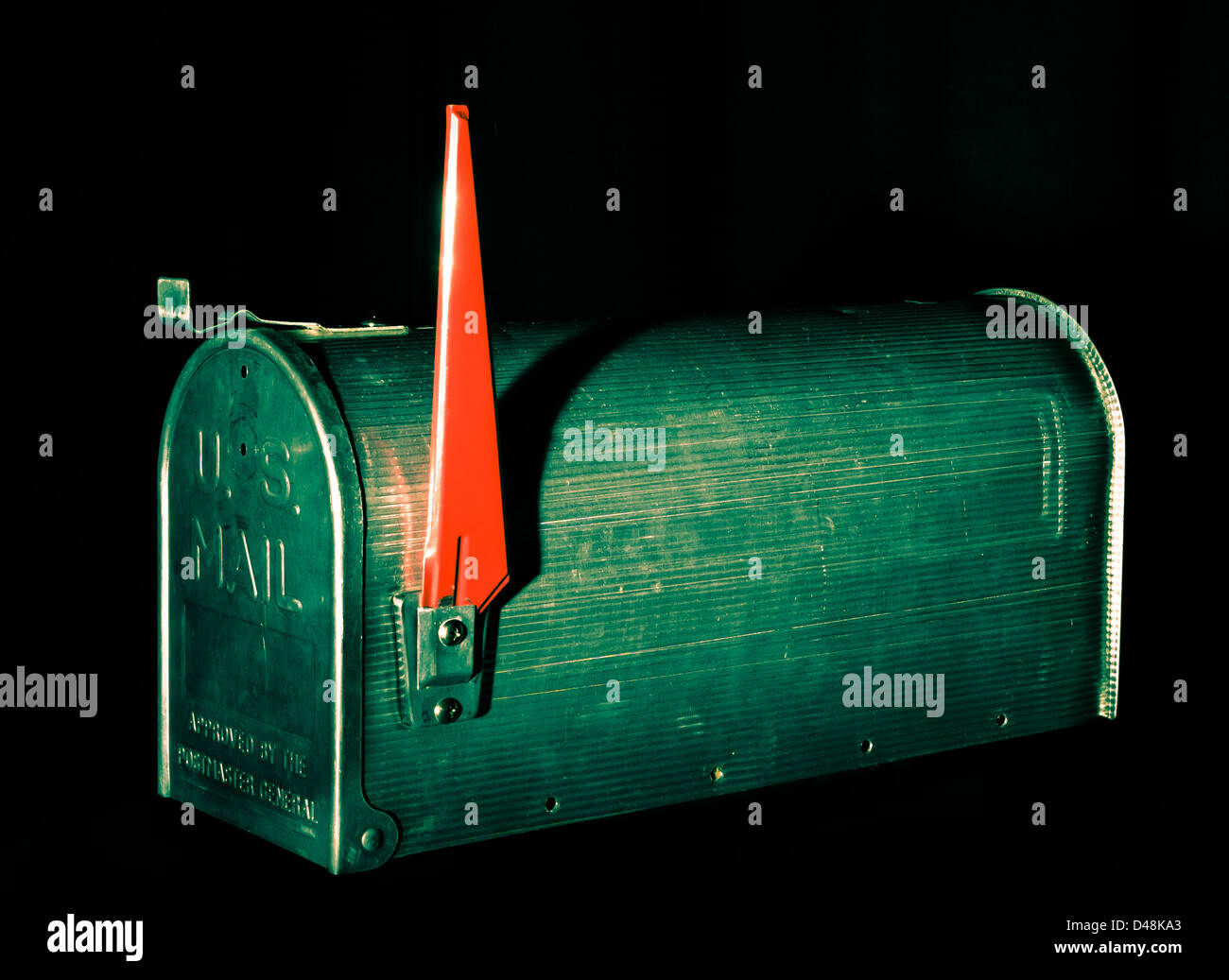 A US style rural mailbox on a black background. Mailbox is green with ...
