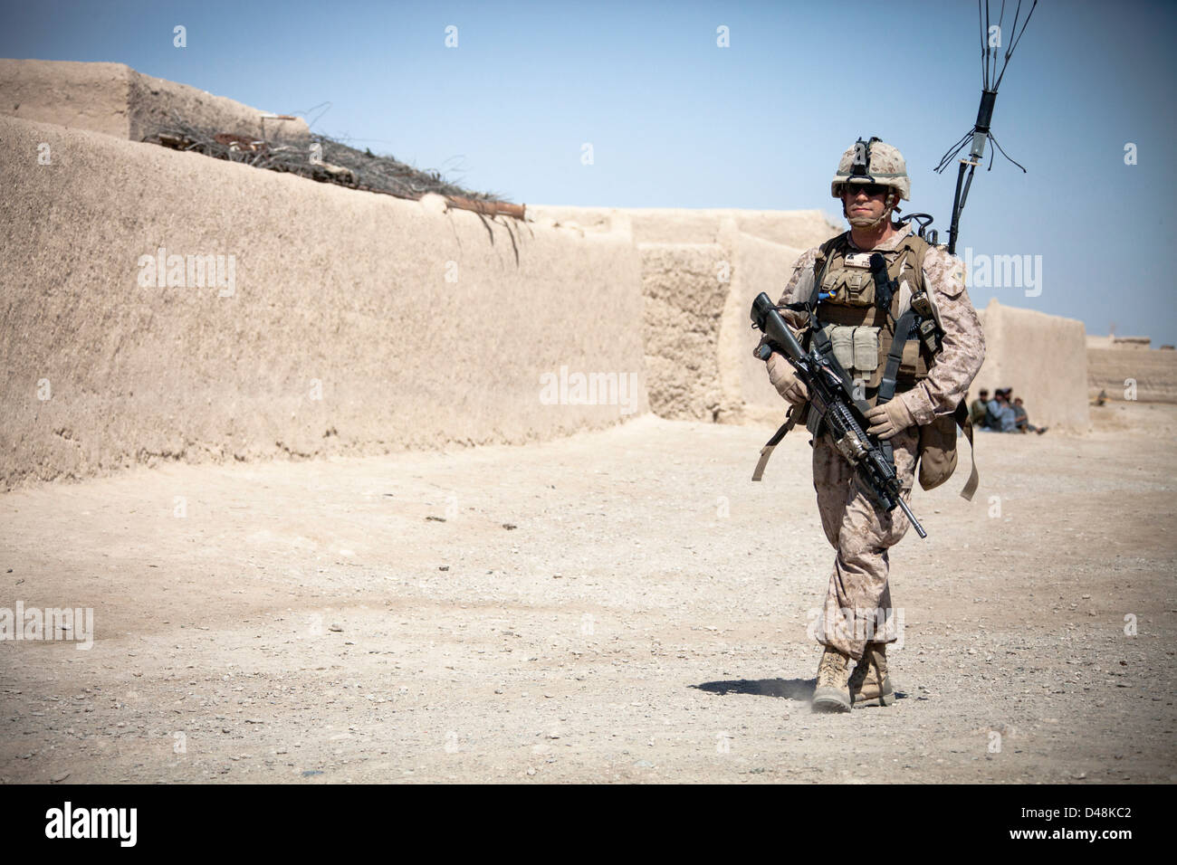 US Marine Corps Cpl. Bradley Weeks patrols a village during combat ...