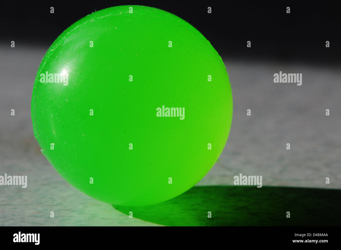 Close up of a green ball on black and white background Stock Photo - Alamy