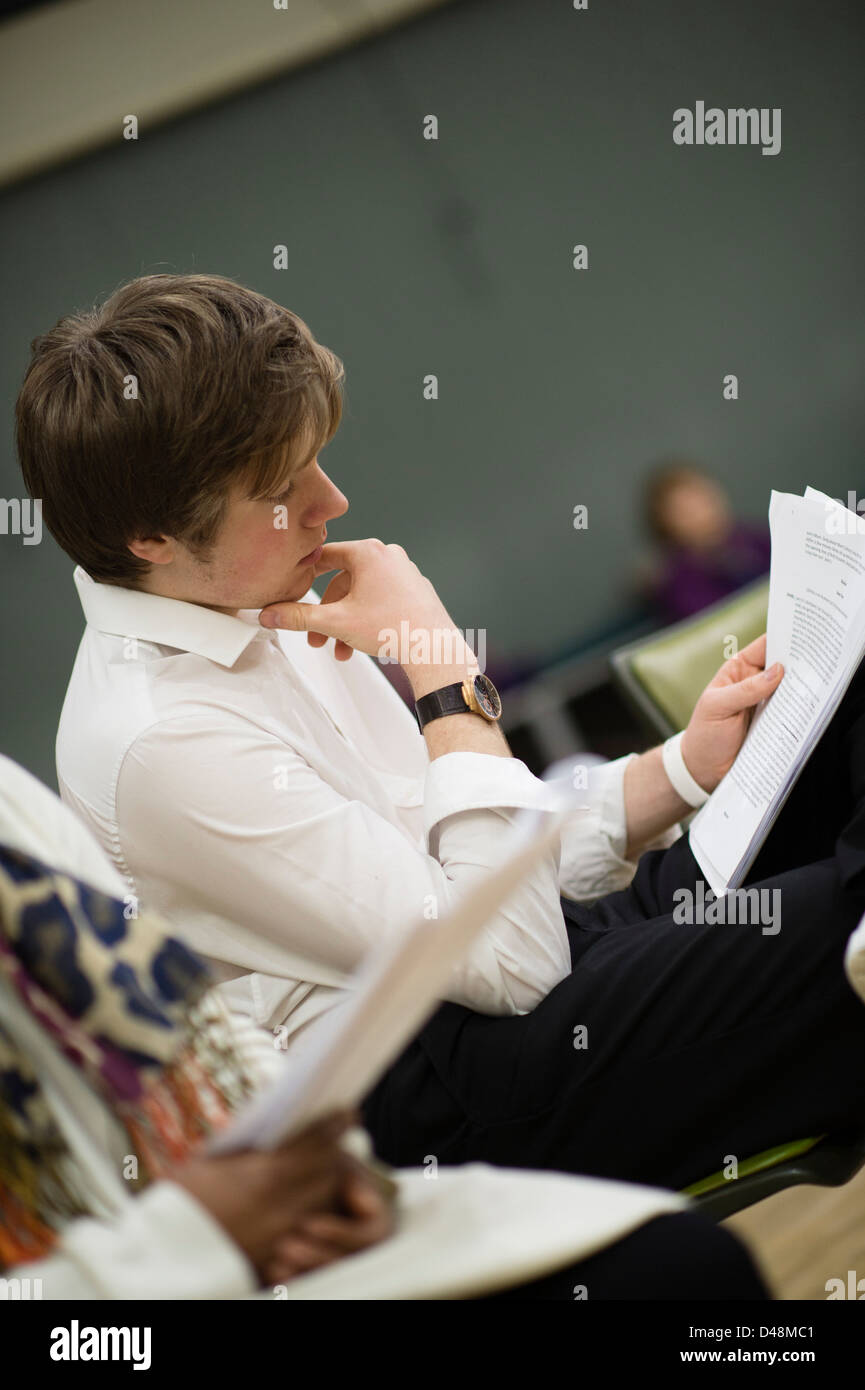 Two Actors in a rehearsal, holding their scripts, reading lines of ...