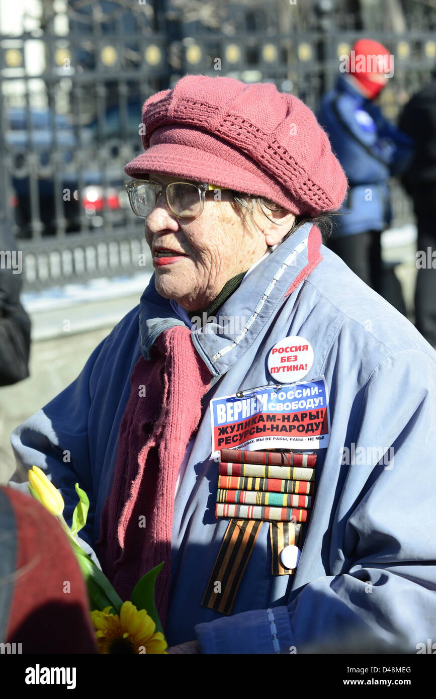 Elder russian woman activist with flowers and signs reads 'Russia ...