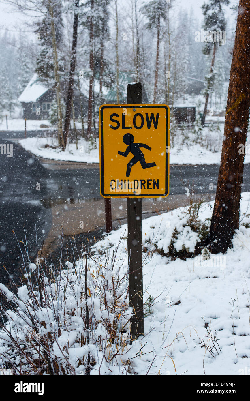 Traffic sign warning drivers to slow down and be aware of playing ...